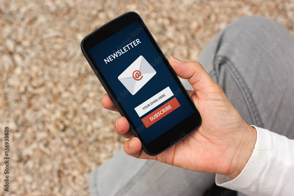 Hand holding smart phone with subscribe newsletter concept on screen ...