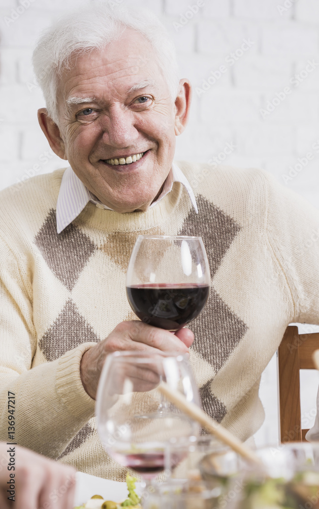 Cheerful elderly man making a toast Stock-Foto | Adobe Stock