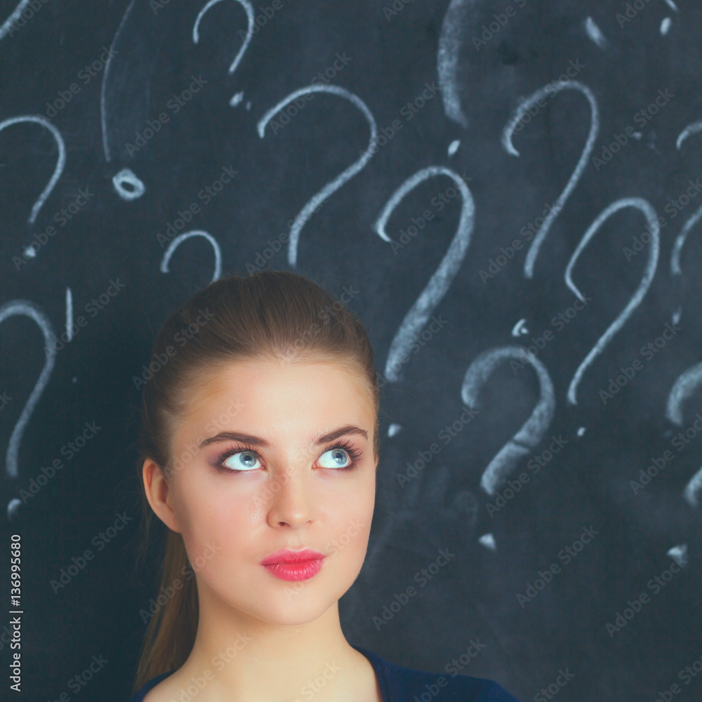 Young girl with question mark on a gray background Stock Photo | Adobe ...
