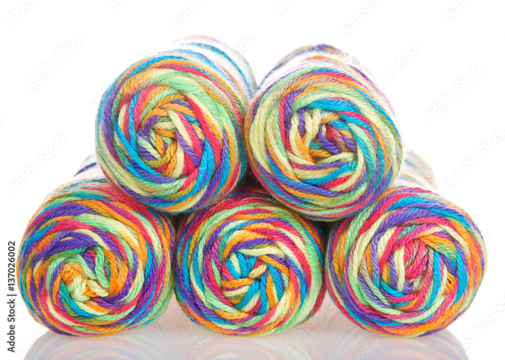 Skeins of rainbow multi colored yarn stacked into a pyramid formation ...