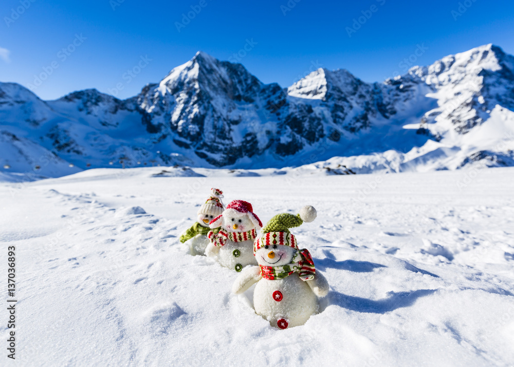 Winter season, snowman on ski run in Italian Alps. Solda with Ortler ...