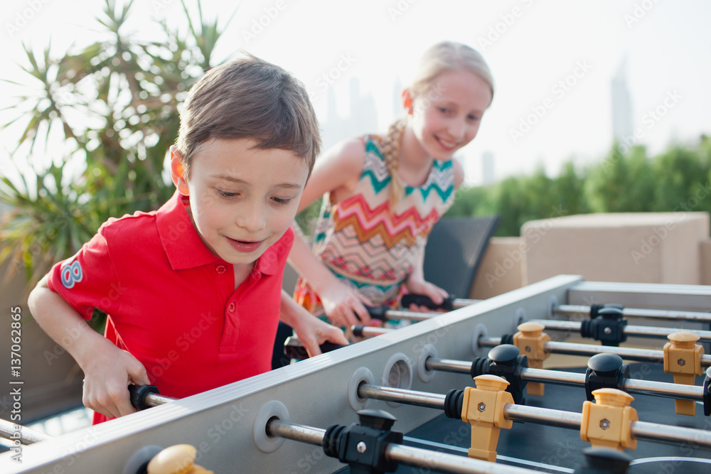 Children playing foosball. Stock Photo | Adobe Stock