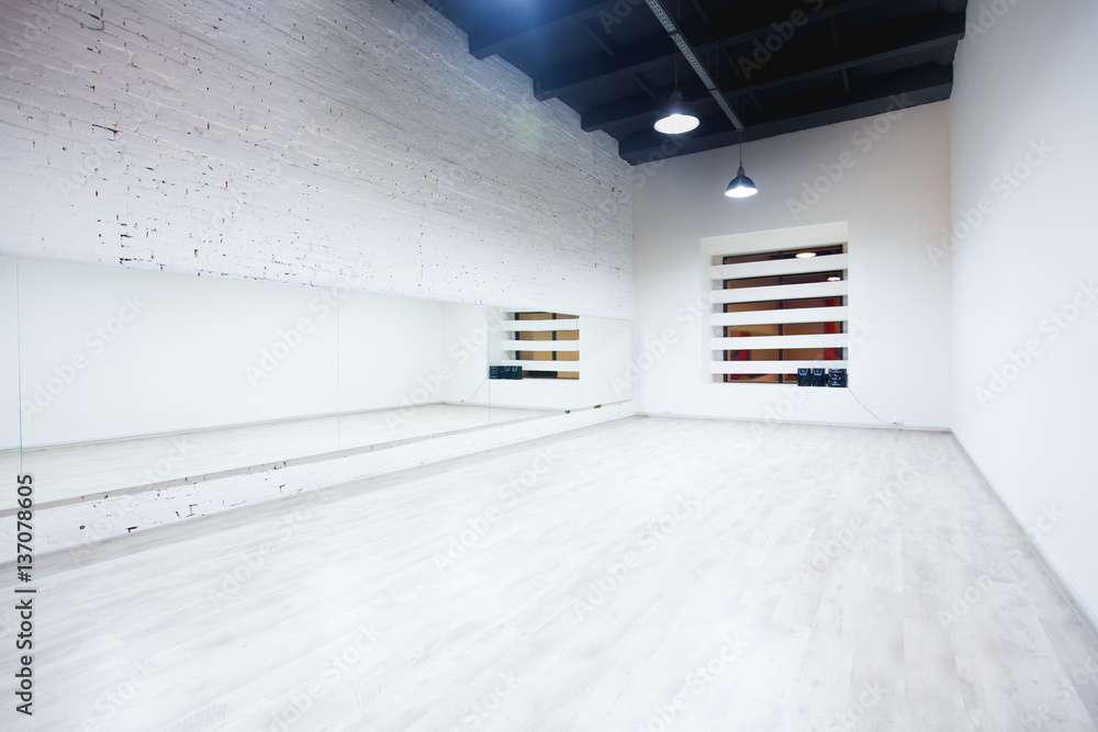 Interior of an empty dance and fitness studio with loft design and big ...