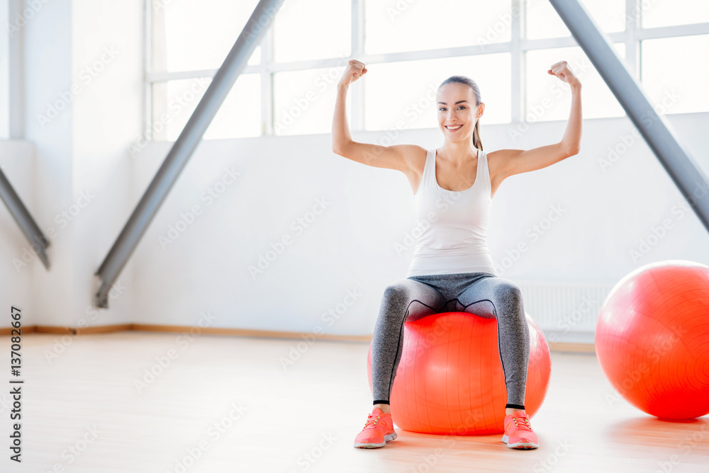 Strong well built woman showing her muscles Stock Photo | Adobe Stock
