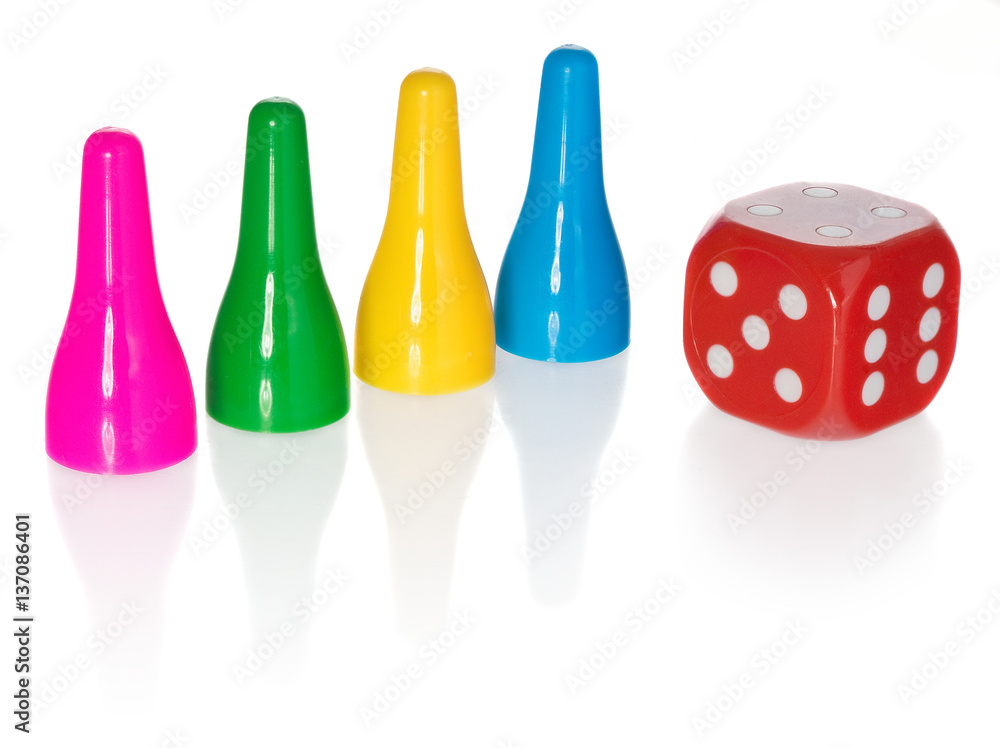 Colored pawns and red dice. Set pieces in the colors yellow, green ...