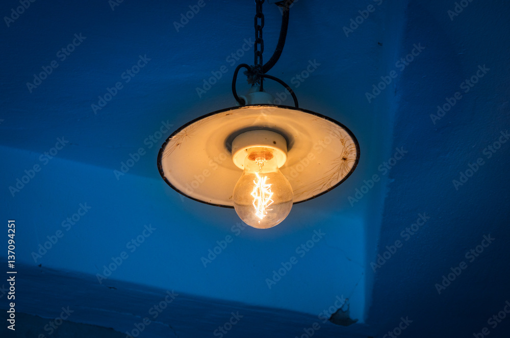 Lighting light bulb on the cable in dark room Stock Photo | Adobe Stock