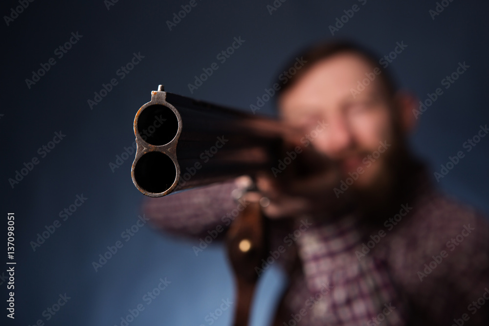 Man holding a shotgun Stock Photo | Adobe Stock