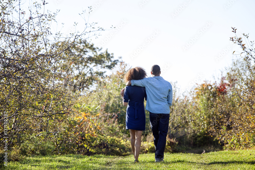 Back view of young couple walking in park Stock Photo | Adobe Stock