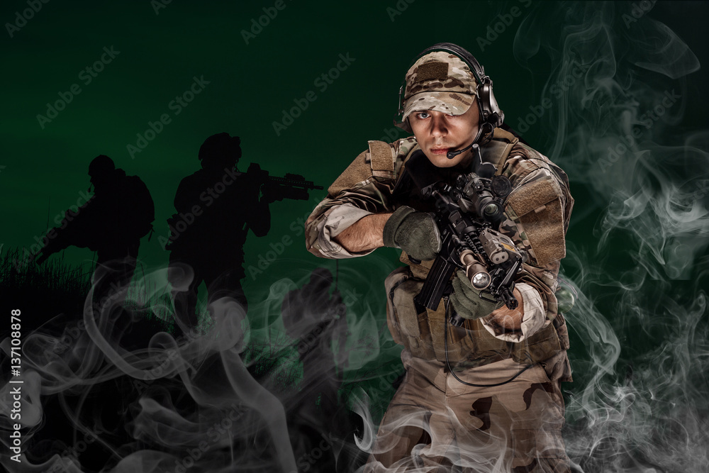 Portrait soldier or private military contractor holding sniper rifle ...