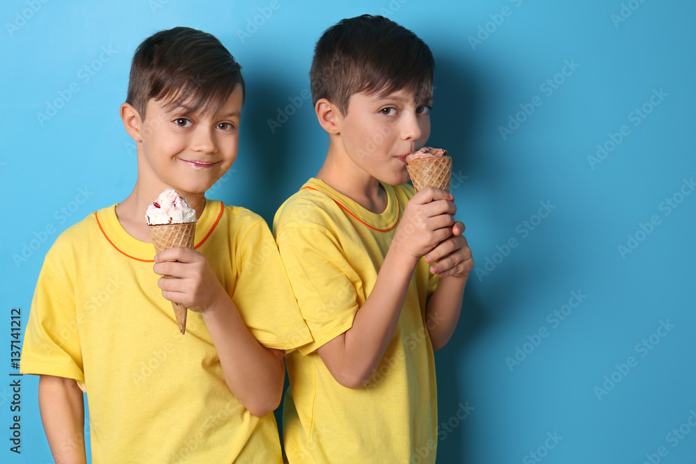 Cute boys with ice cream on blue background Stock Photo | Adobe Stock