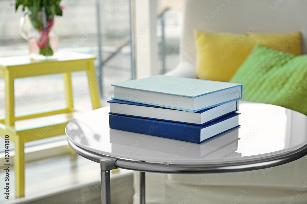 Pile of books on table at home Stock Photo | Adobe Stock