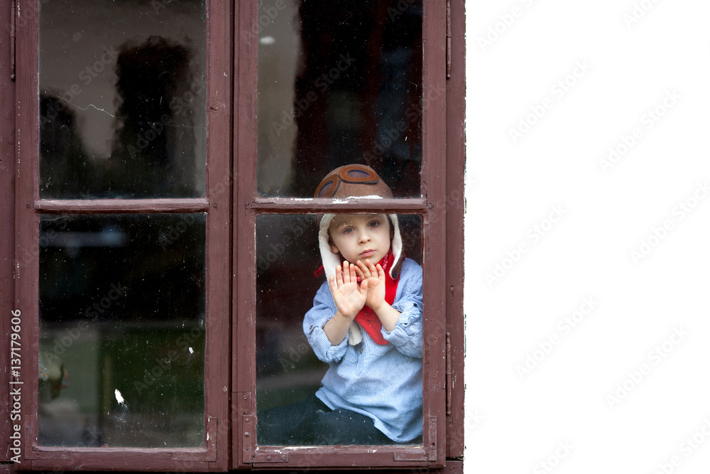 Sad little boy, sitting behind the window Stock Photo | Adobe Stock