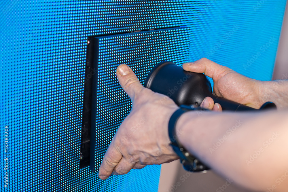 Manual assembling of the LED screen cluster foto de Stock | Adobe Stock