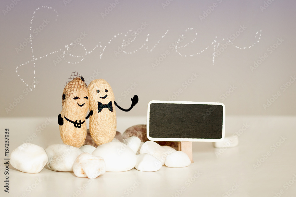 Forever love idea. Two peanuts with drawn faces hugging on pink vanilla ...