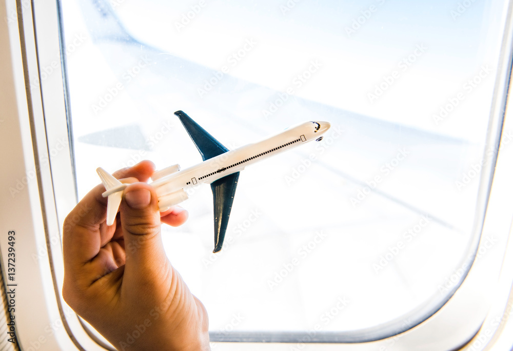 Hand of boy playing with toy airplane at airplane window Stock Photo ...
