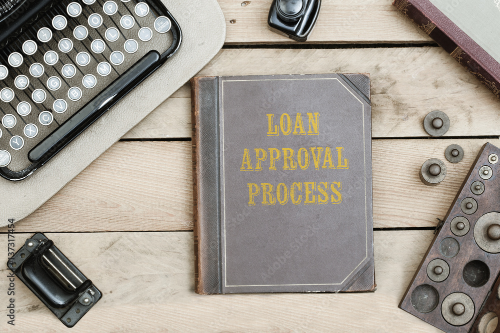 Loan Approval Process on old book cover at office desk with vintage ...