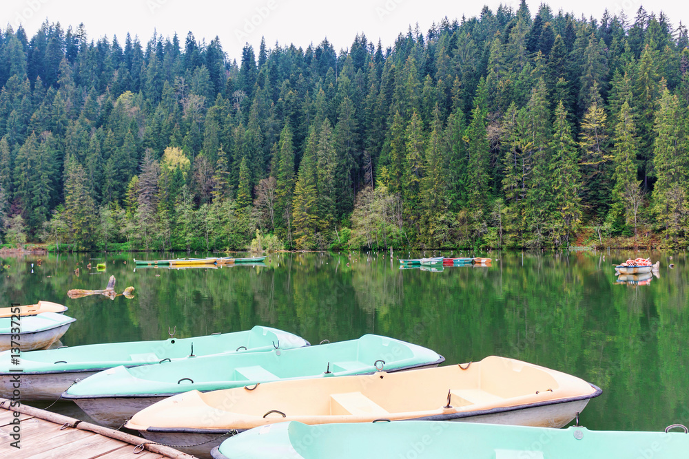 Boats at wooden relaxing area on the sovata lake in romania, rest area ...
