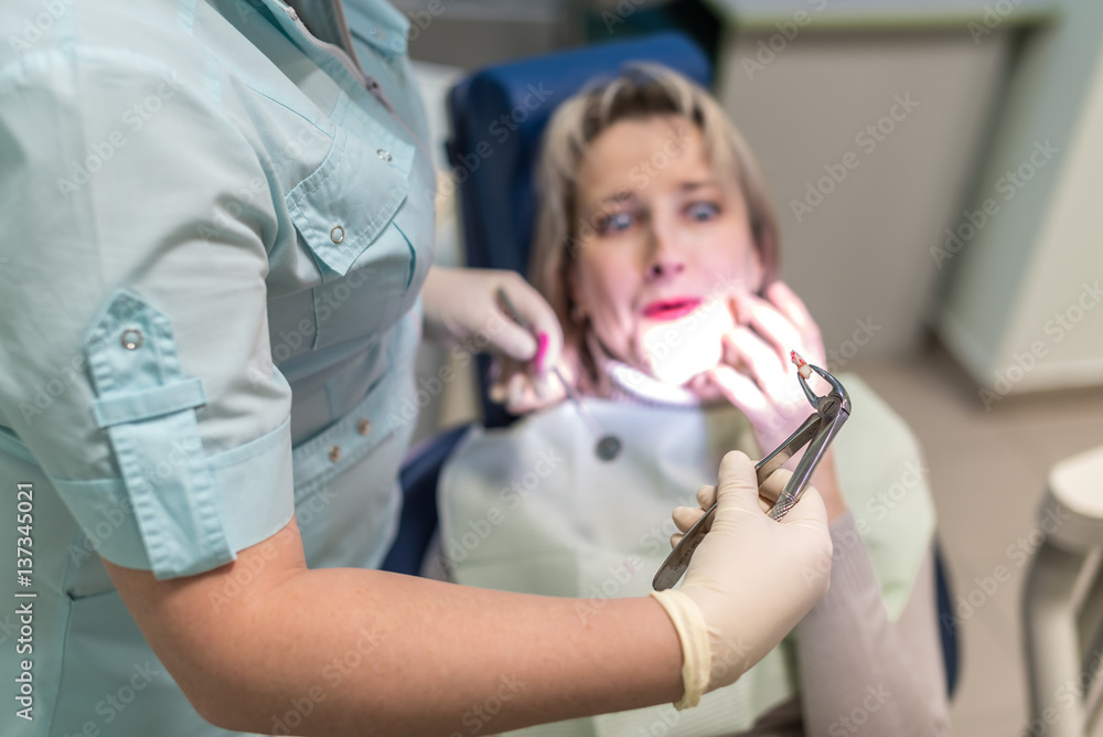 dentist removes the tooth patient at the dental clinic Stock Photo ...