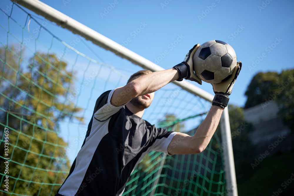goalkeeper with ball at football goal on field Stock Photo | Adobe Stock