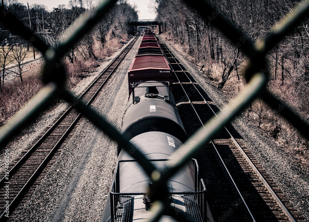 Abstract image of train yard. Looking through chain link fence with ...
