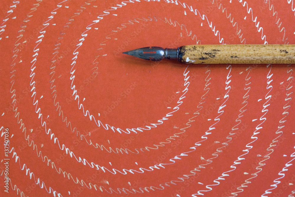 Fountain pen on red textured paper background with abstract letters ...