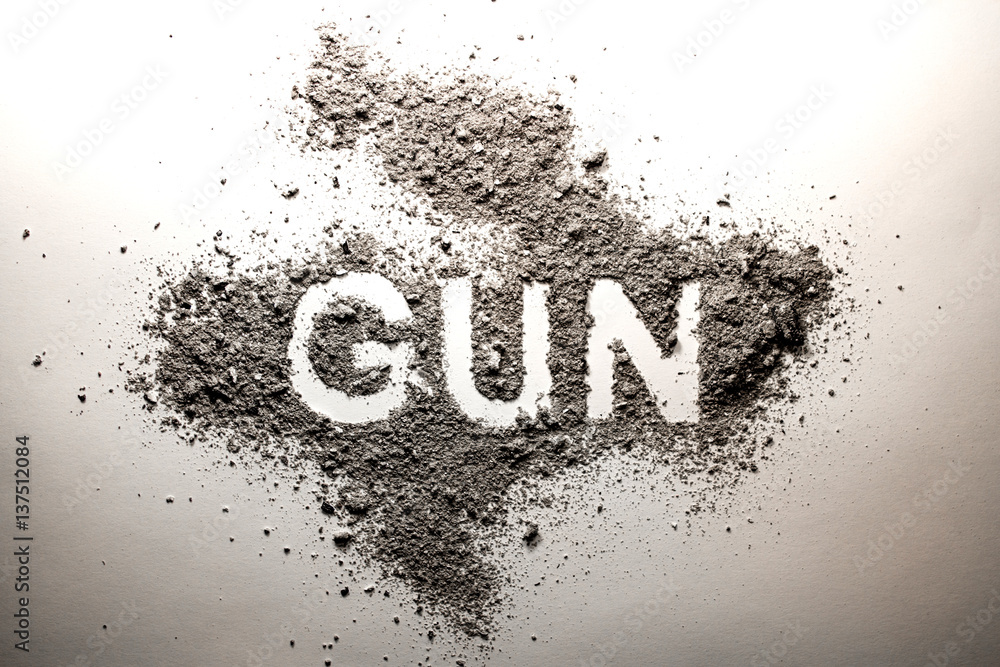 Gun word written in ash as crime, criminal, violence, murder, death ...