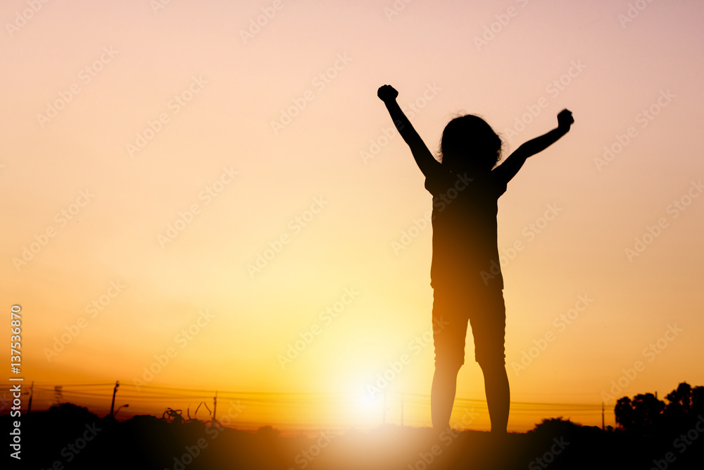 Silhouettes of little girl playing at sunset evening sky background ...