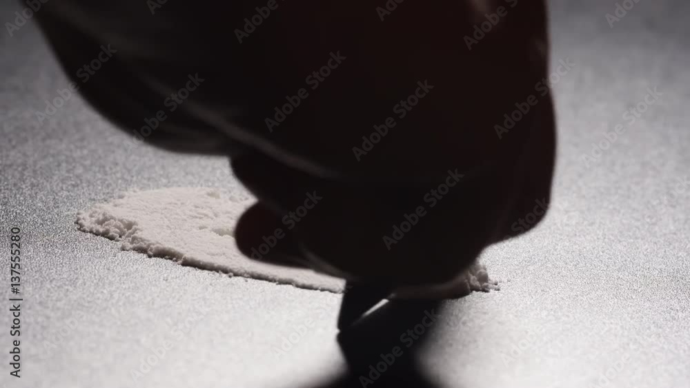 DRUGS: Silhouette of Man does a lines of heroin by plastic card Stock ...