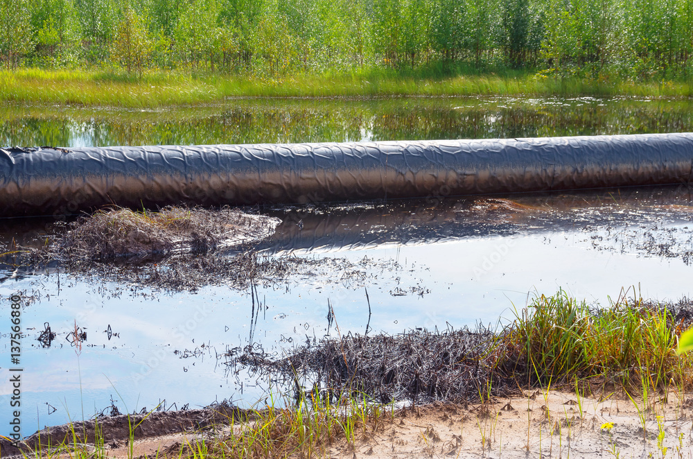 An accident on an oil pipeline. An oil spill around the pipeline ...