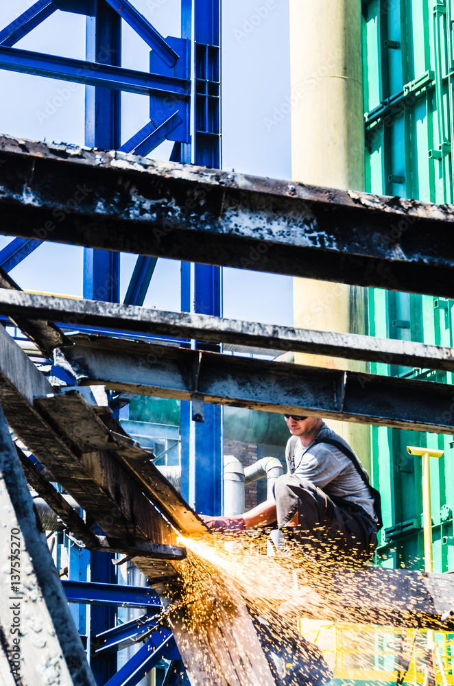 Cutting steel structure. Work at height. Man working on the demolition ...