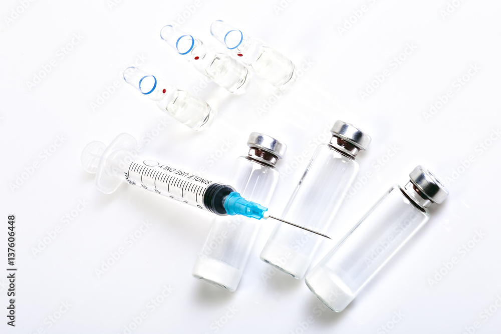 Medical syringe, three ampules with saline and vials with dry human ...
