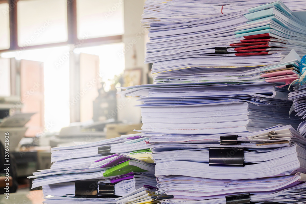 Pile of documents on desk stack up high waiting to be managed Stock ...