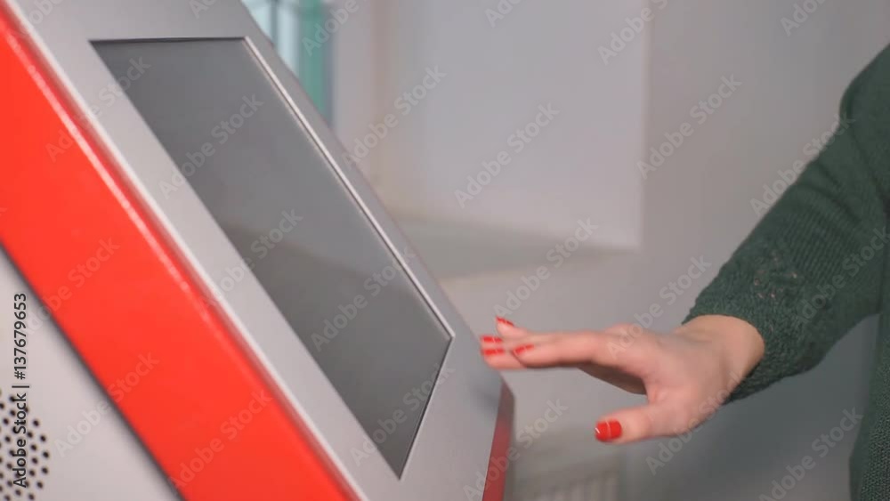 Monitor Touchscreen ATM A woman uses an ATM to withdraw money from your ...