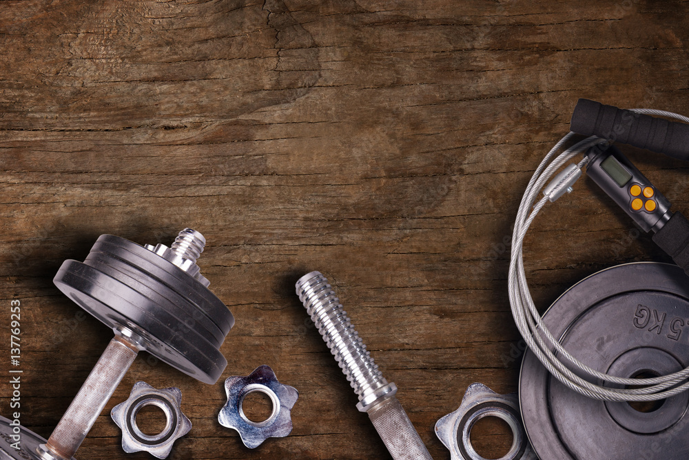 Weights at the gym whit handle and barbell. Stel gym equipment on dark ...