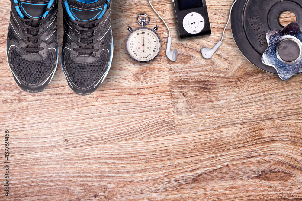 Fitness gym and running equipment. Dumbbells and running shoes, analog ...