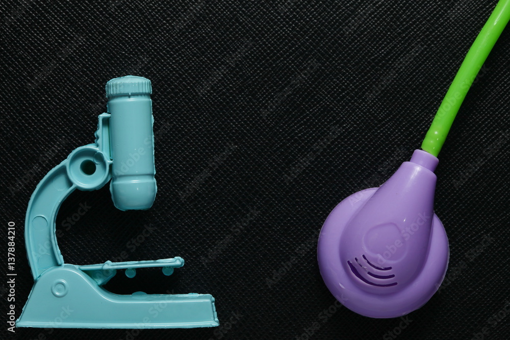 Artificial plastic toy model of microscope blue color and stethoscope ...