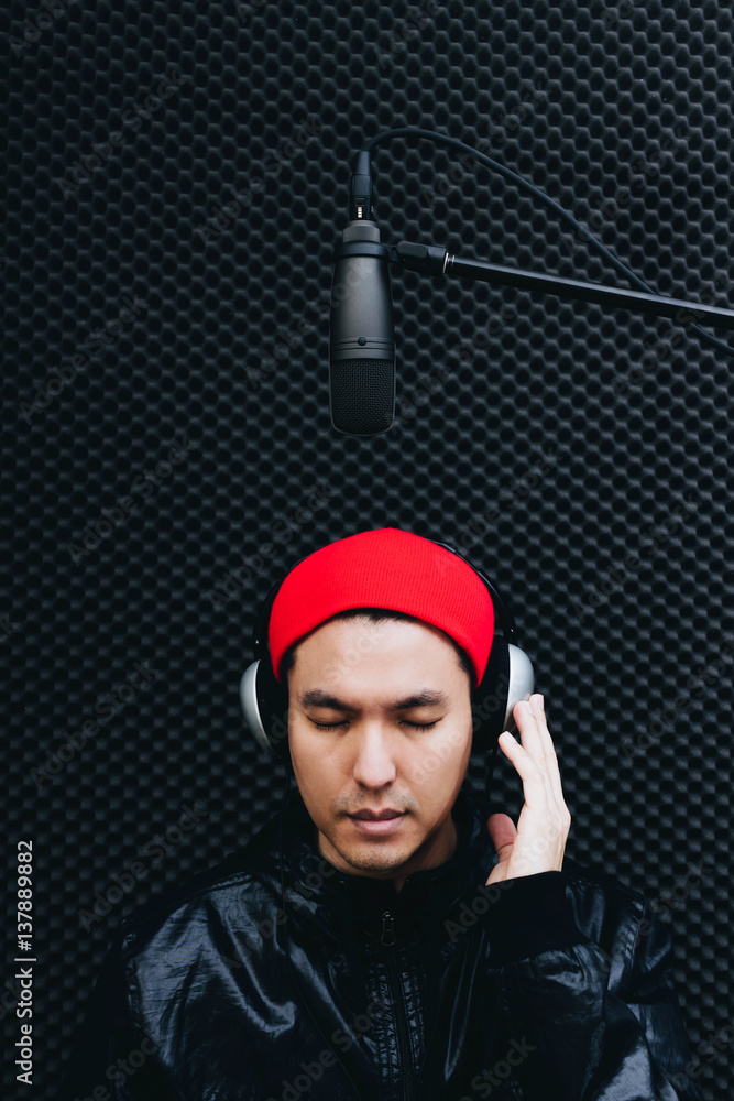 asian handsome voice actor, singer concentrate in recording studio for ...