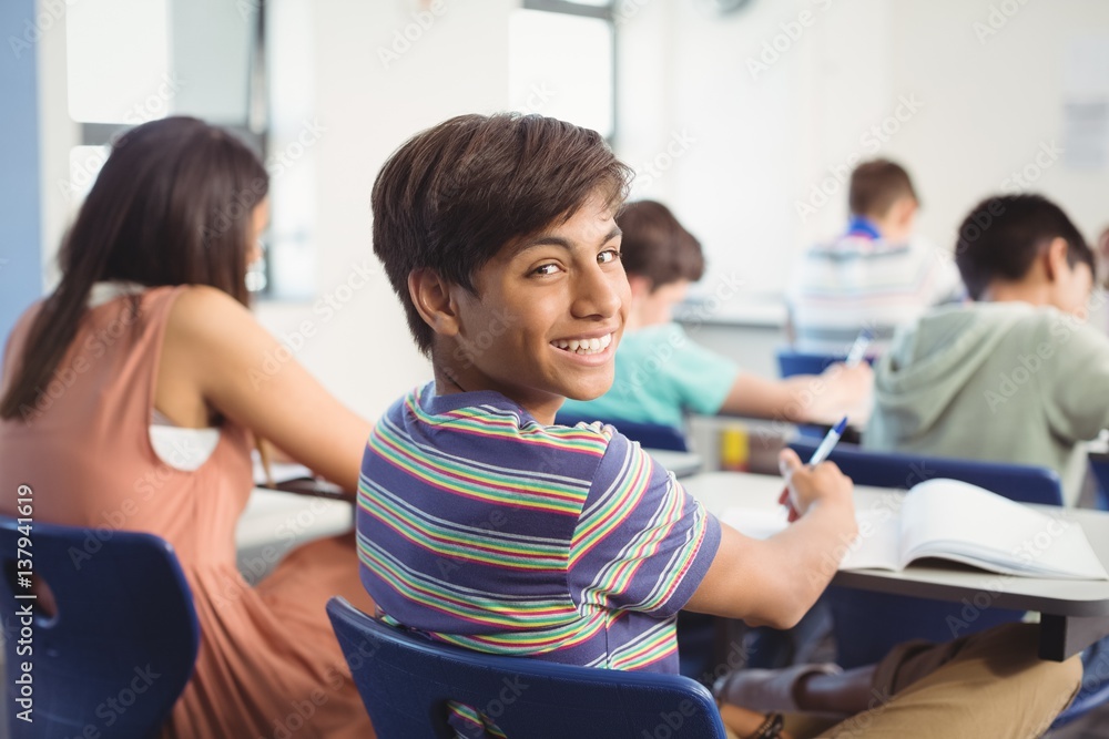 School kids doing homework in classroom Stock Photo | Adobe Stock