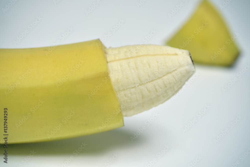 banana with the skin of its tip removed Stock Photo | Adobe Stock