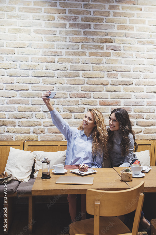 Foto Stock Two Pretty Women Taking Selfie At Coffee Shop Adobe Stock