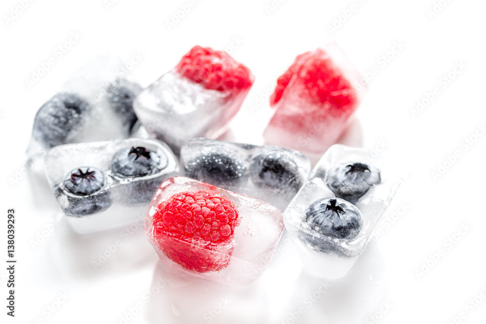 frozen blueberry and raspberry in icecubes on white background Stock ...