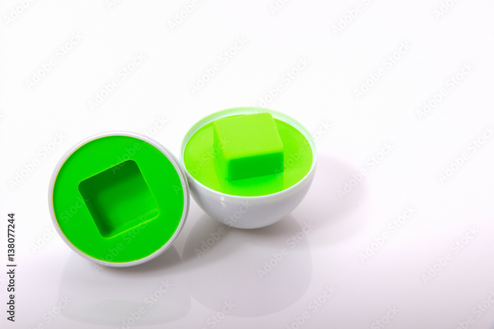Plastic egg developmental puzzle of green color with the shape of a ...