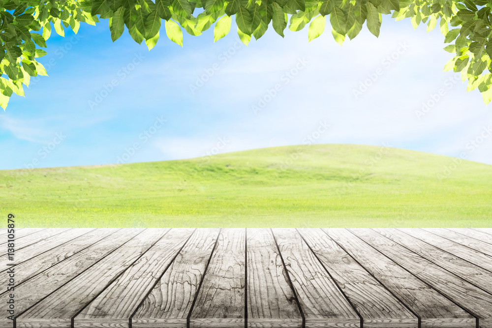 Wood table top on mound slope green grass natural background. concept ...