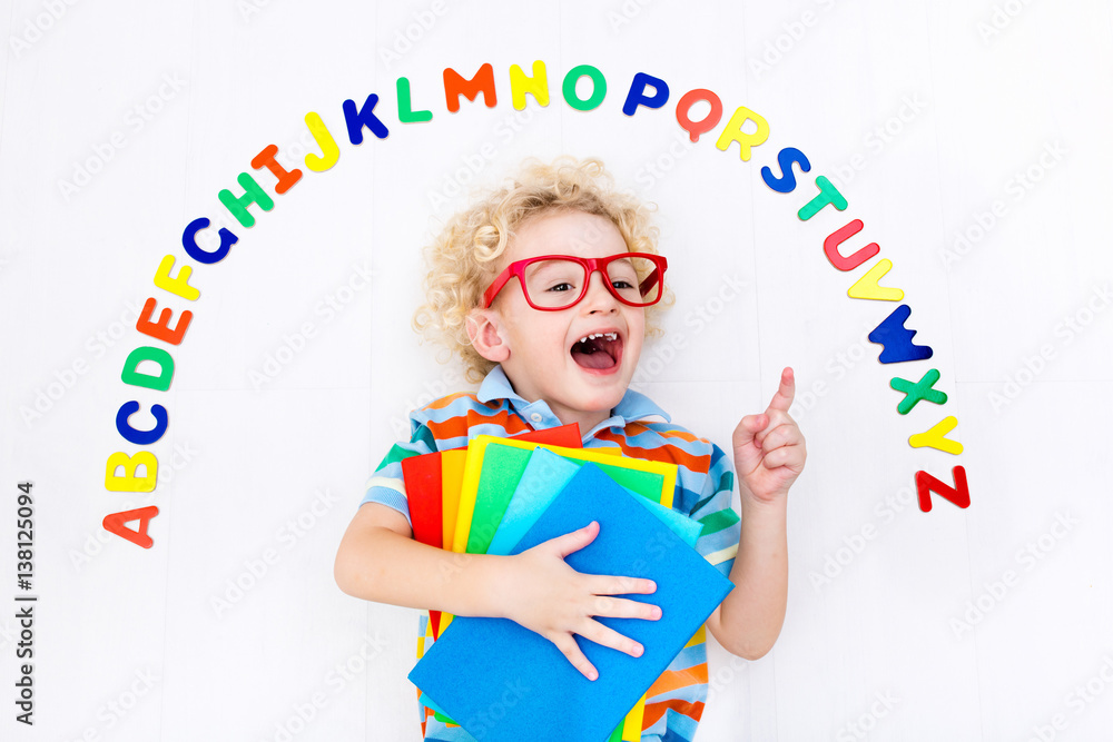 Child learning letters of alphabet and reading Stock Photo | Adobe Stock