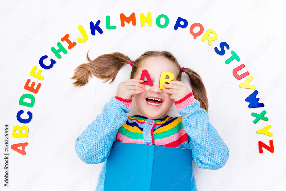 Child learning letters of alphabet and reading Stock Photo | Adobe Stock