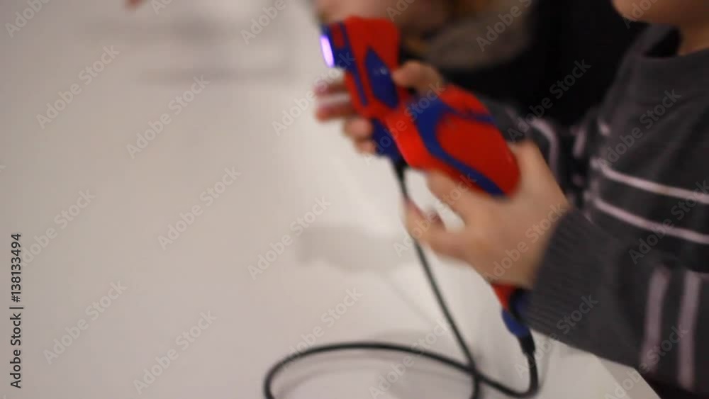 Boy hands holding remote controlling robot. Close up of remote ...