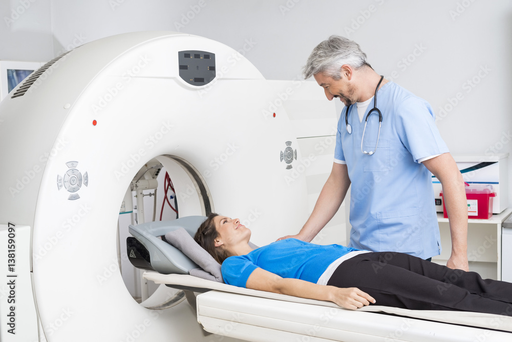 Smiling Doctor Talking To Patient Lying On CT Scan Machine Stock Photo ...