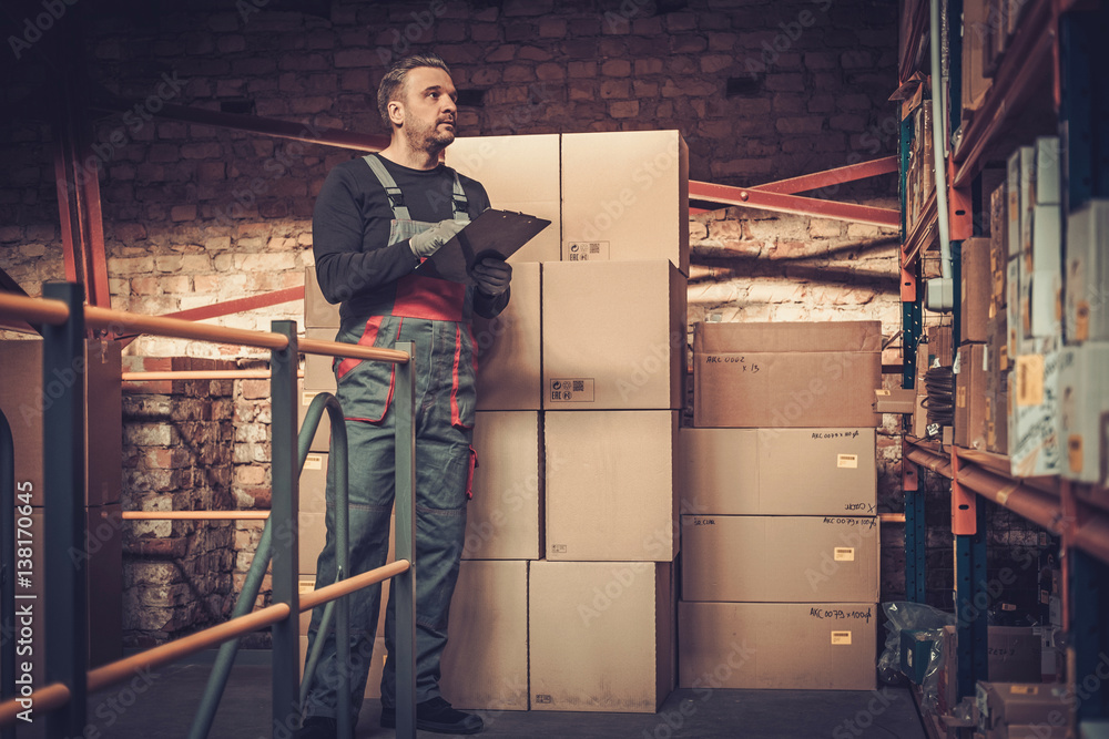 Storekeeper with manual pick list on a warehouse Stock Photo | Adobe Stock