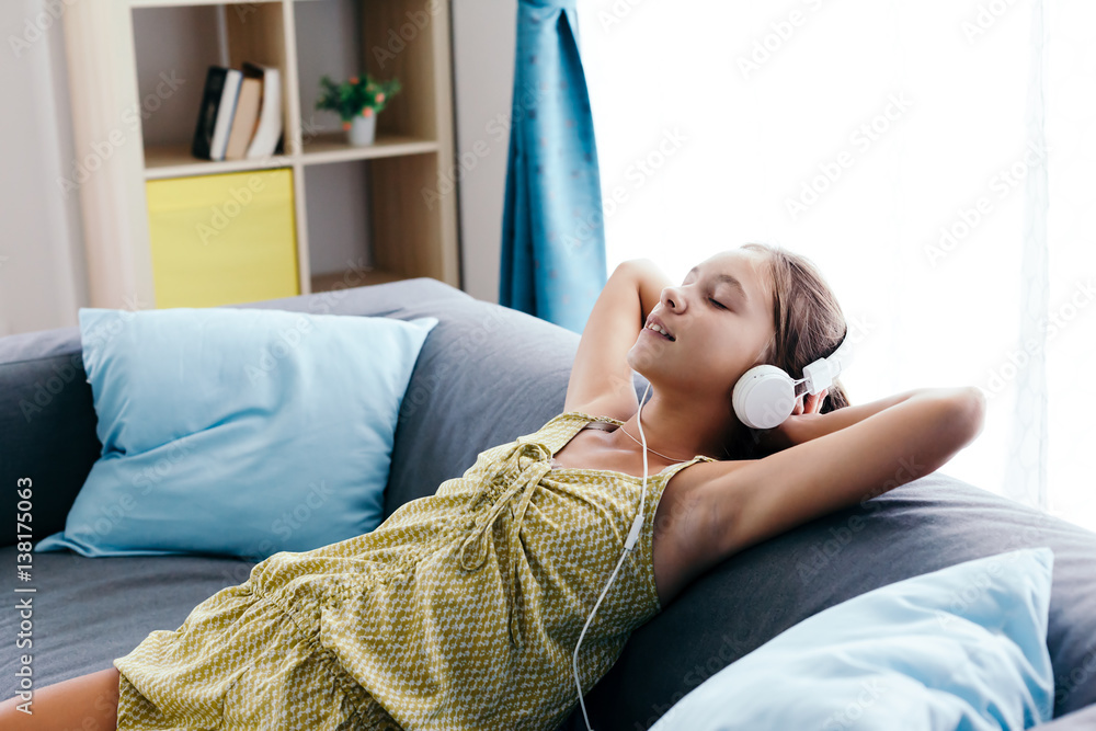Tween girl relaxing on couch at home Stock Photo | Adobe Stock