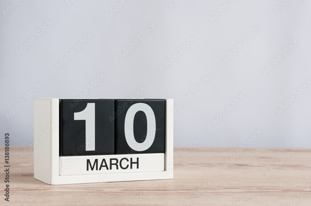 March 10th. Day 10 of month, wooden calendar on light background ...